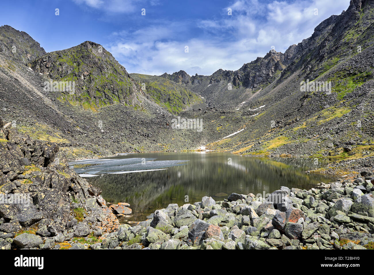 Lake at bottom of mountain depression formed during ice age. Poor ...