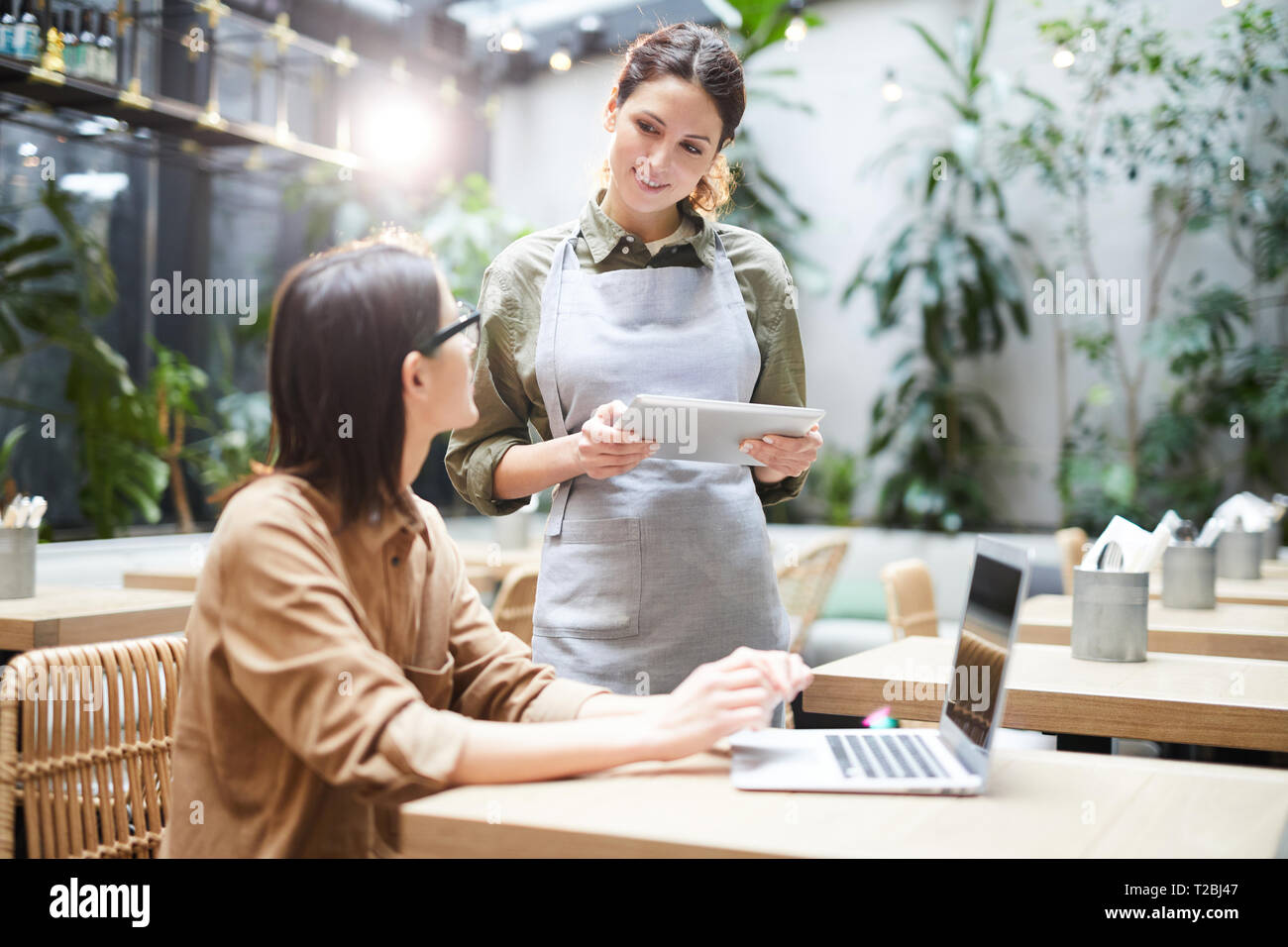 Waitress asking guest about food and drink preferences Stock Photo - Alamy