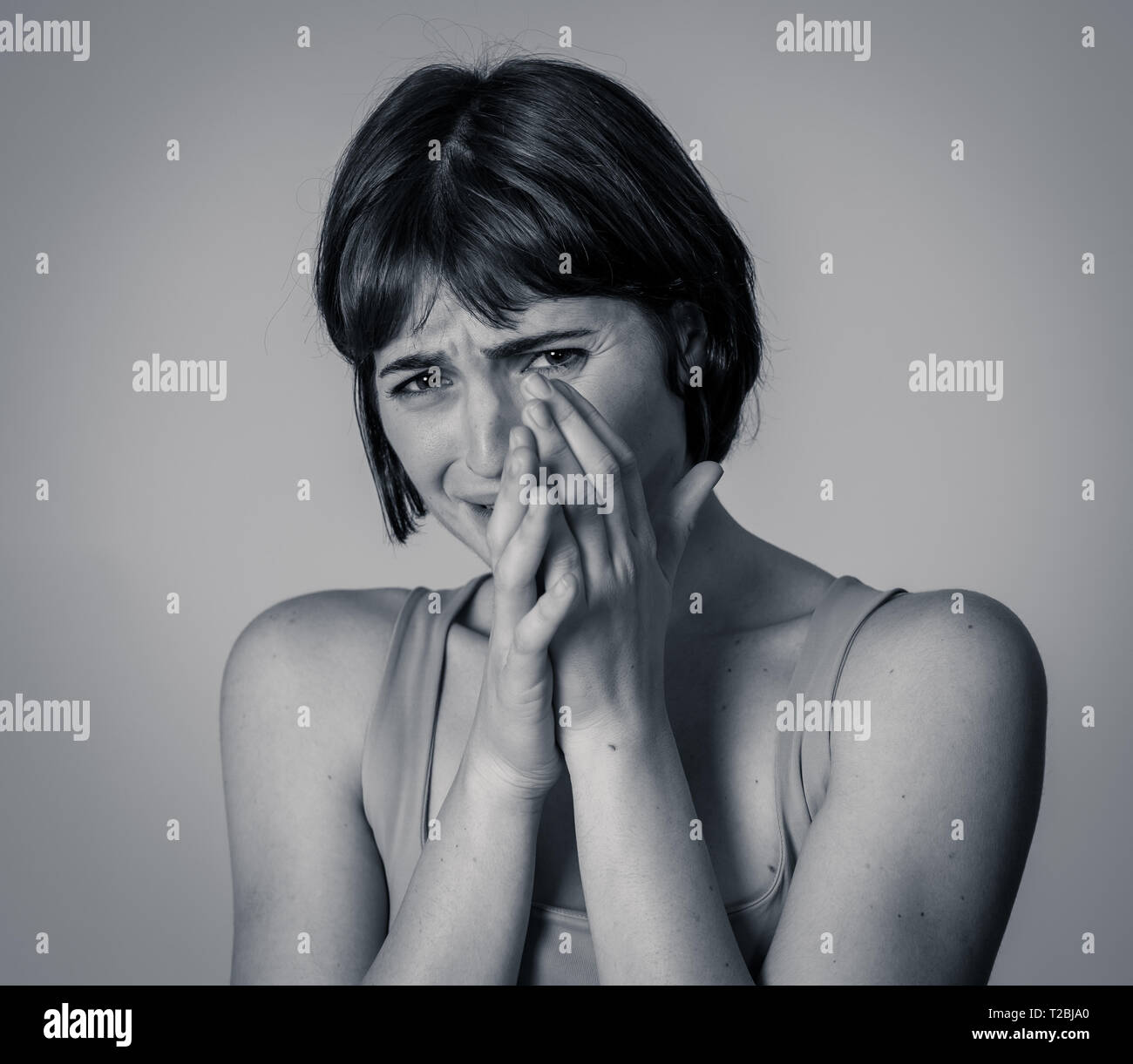 Black and white close up of young woman feeling scared and shocked ...