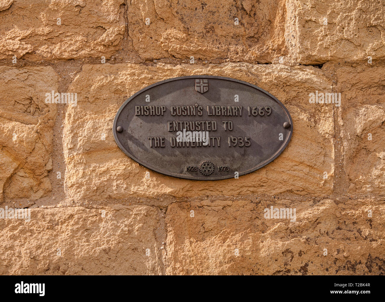 A plaque on a stone wall building of the university library in Durham ...