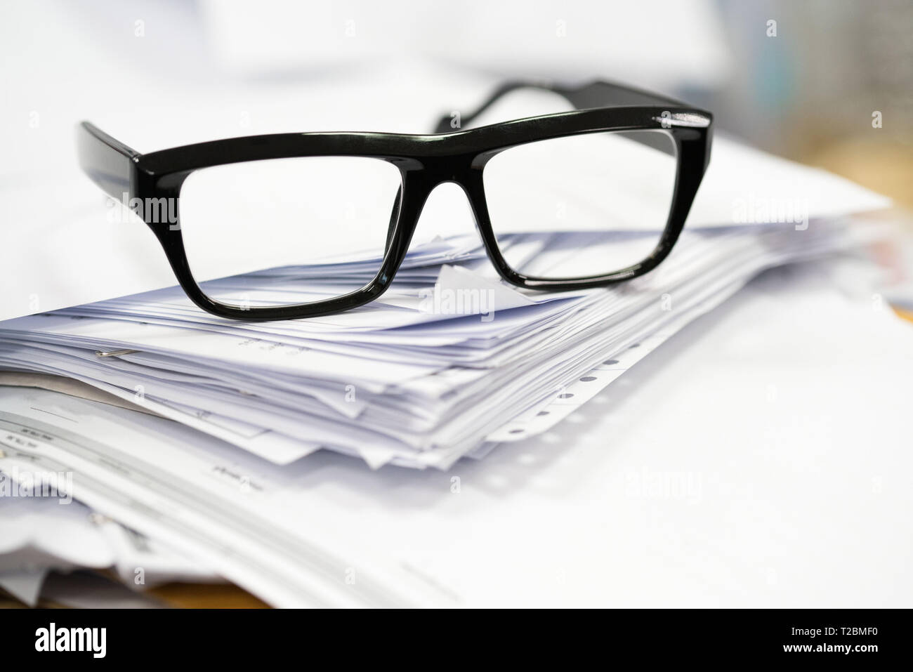 Paper heap from hard work is under black glass Stock Photo - Alamy