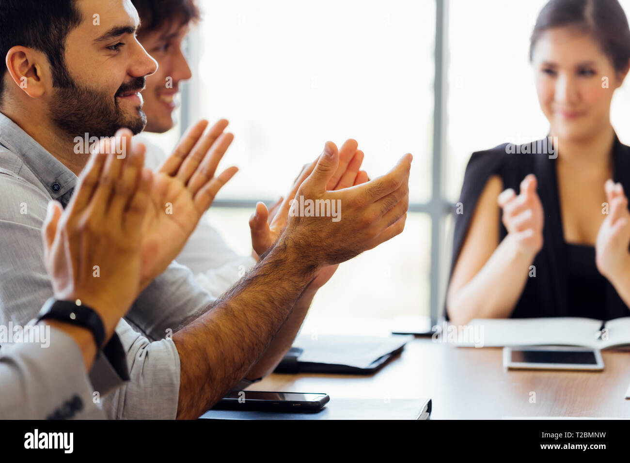 Closeup of businesspersons clapping hands and applauding in business ...