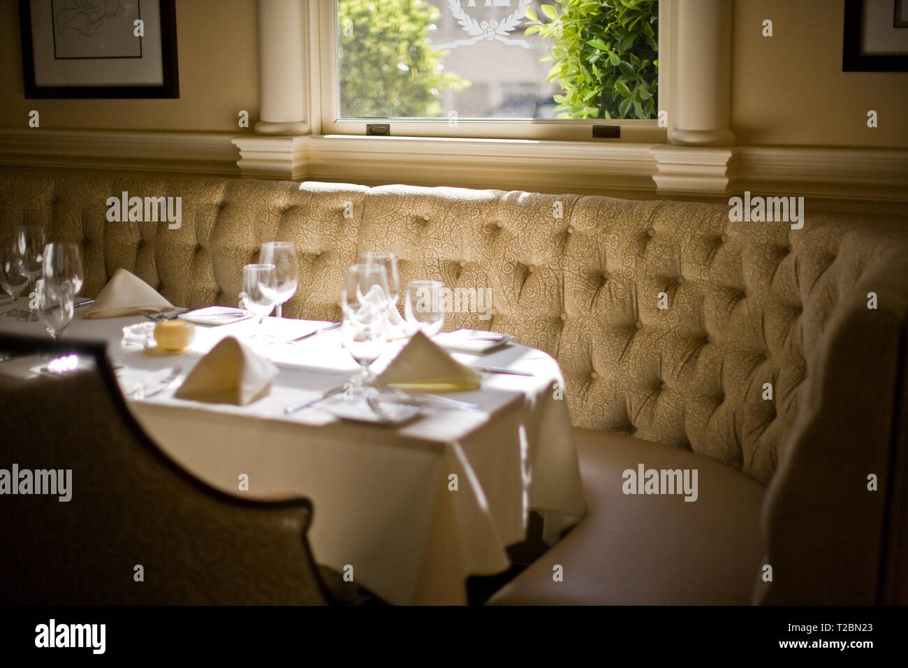 Table laid with cutlery and glasses inside a restaurant Stock Photo - Alamy