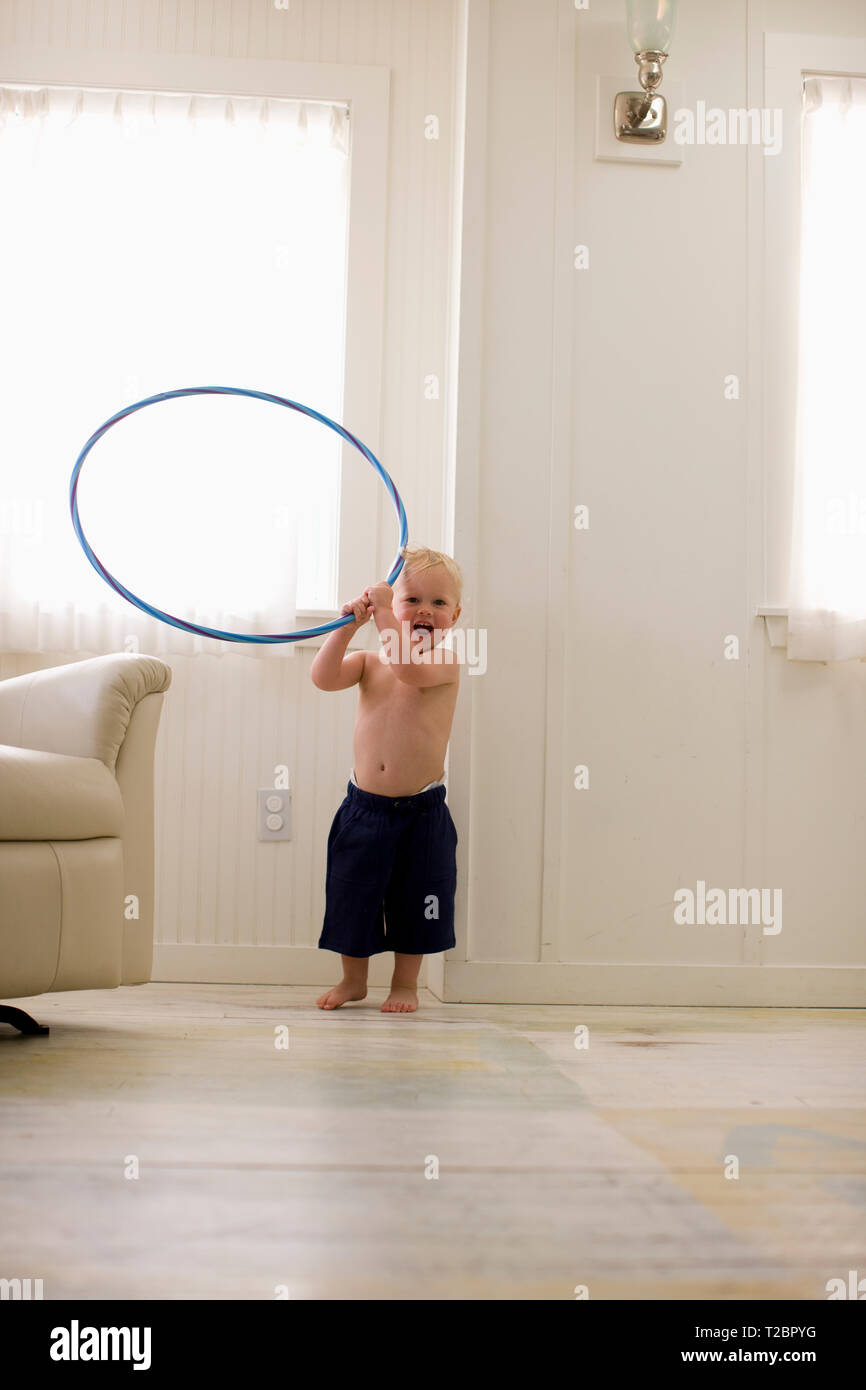 Toddler with a hula hoop Stock Photo - Alamy
