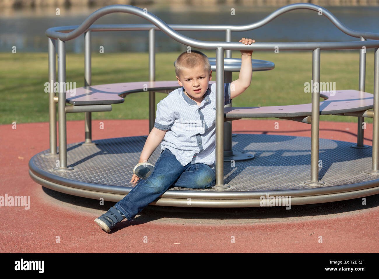 Little boy on a playground. Child playing outdoors in summer. Kids play ...