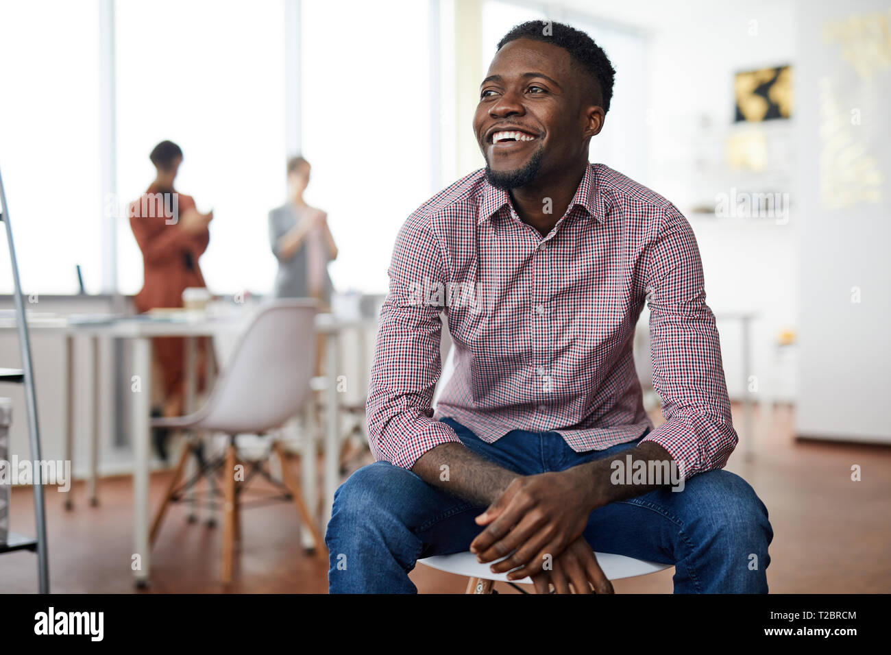 Portrait of contemporary African-American businessman smiling happily ...