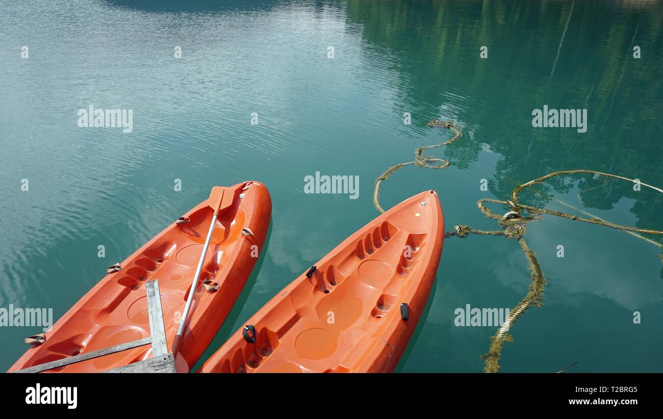 orange paddle boats in khao sok for kayaking Stock Photo - Alamy