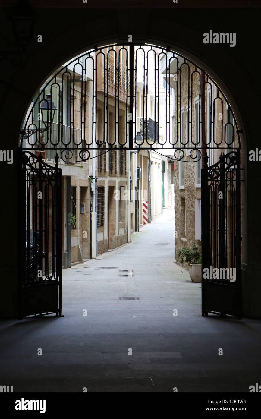 Fancy European gate opening into a narrow street Stock Photo - Alamy