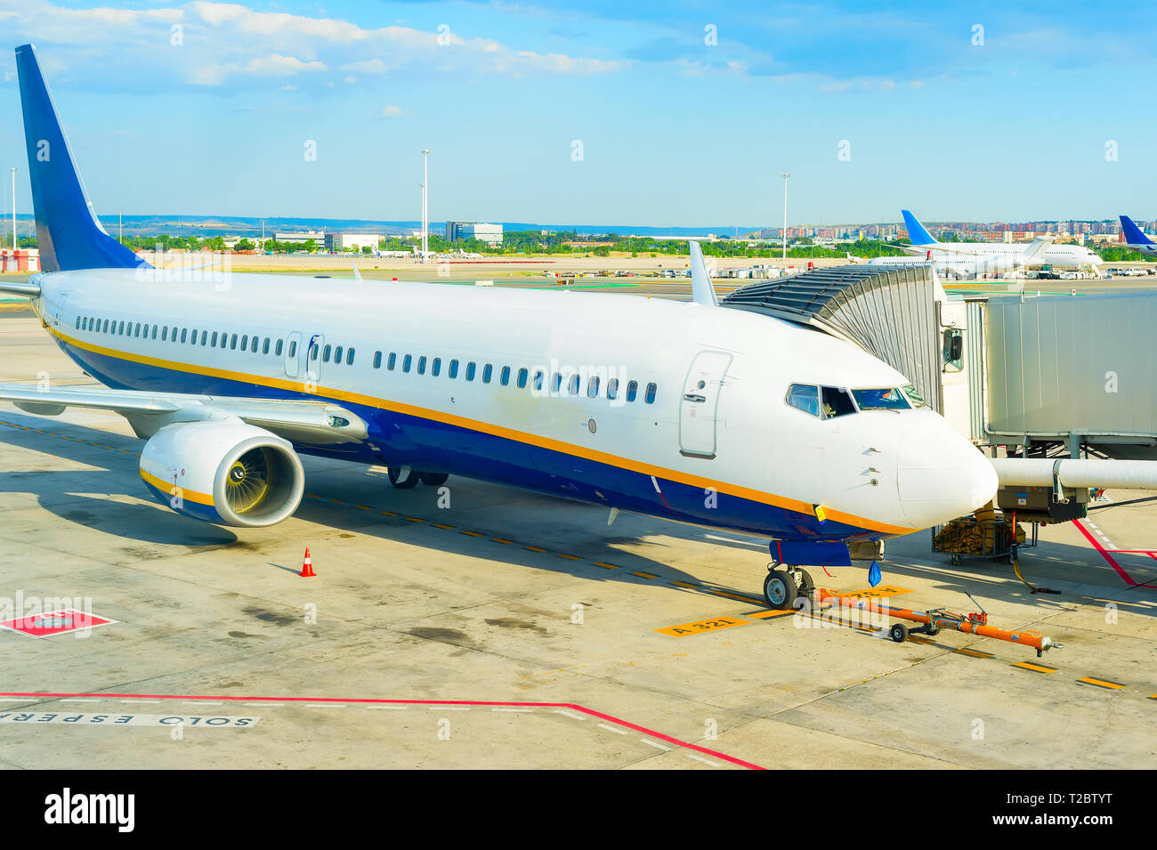 Airplane with gangway at airport runway in sunshine Stock Photo - Alamy