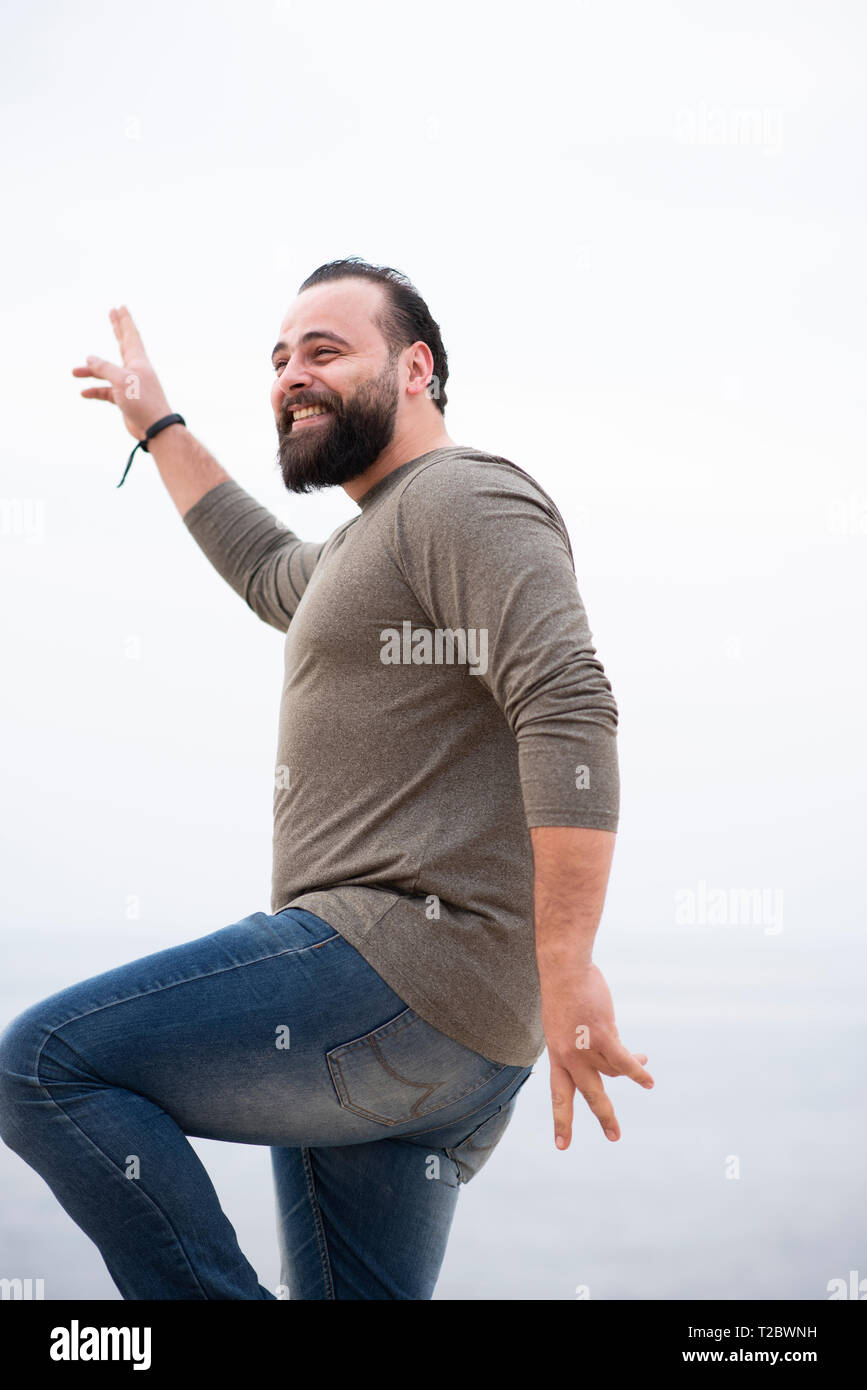 Side view of a big man dancing outdoors Stock Photo - Alamy