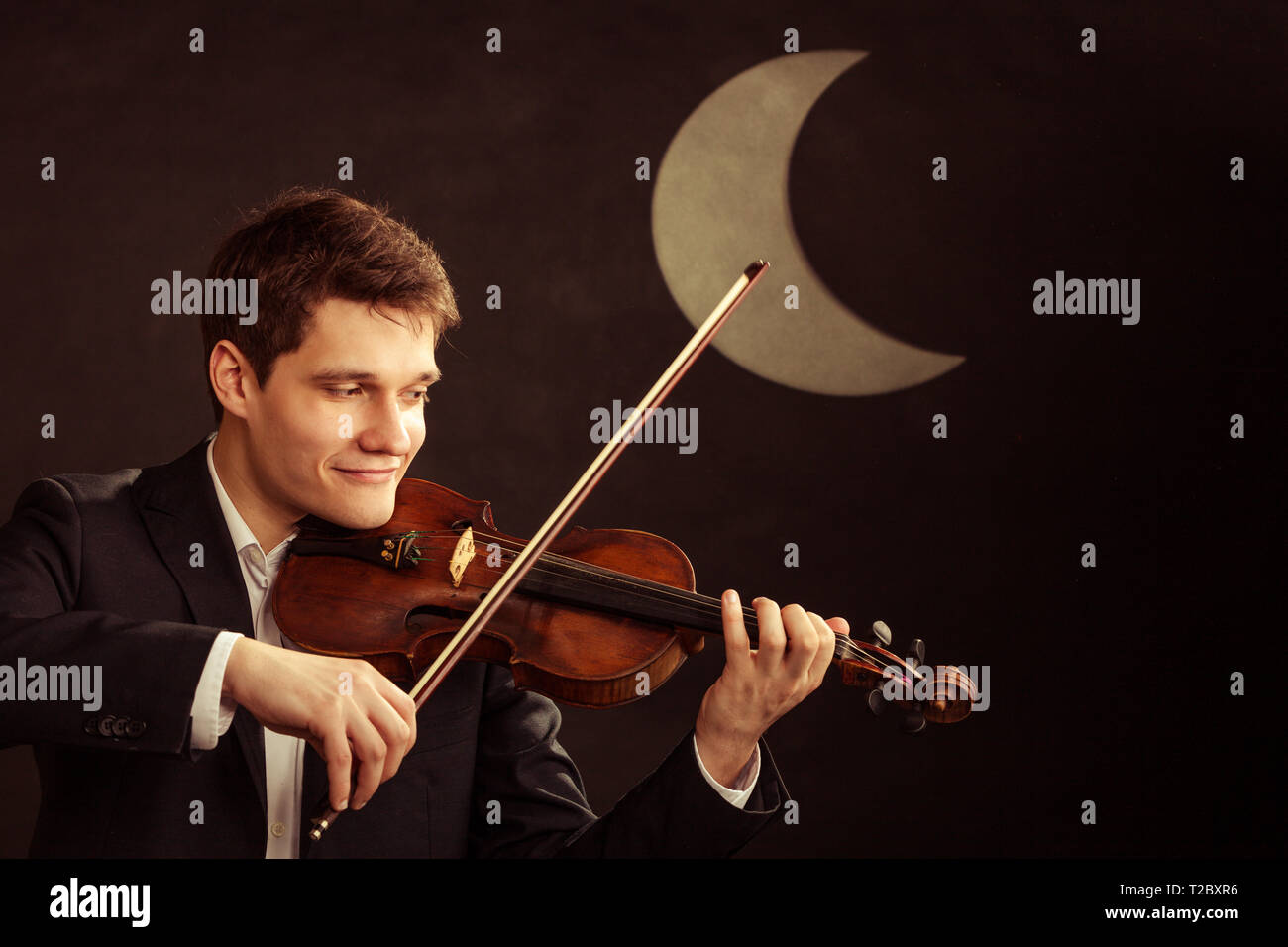 Art and artist. Young elegant in love man violinist fiddler playing ...
