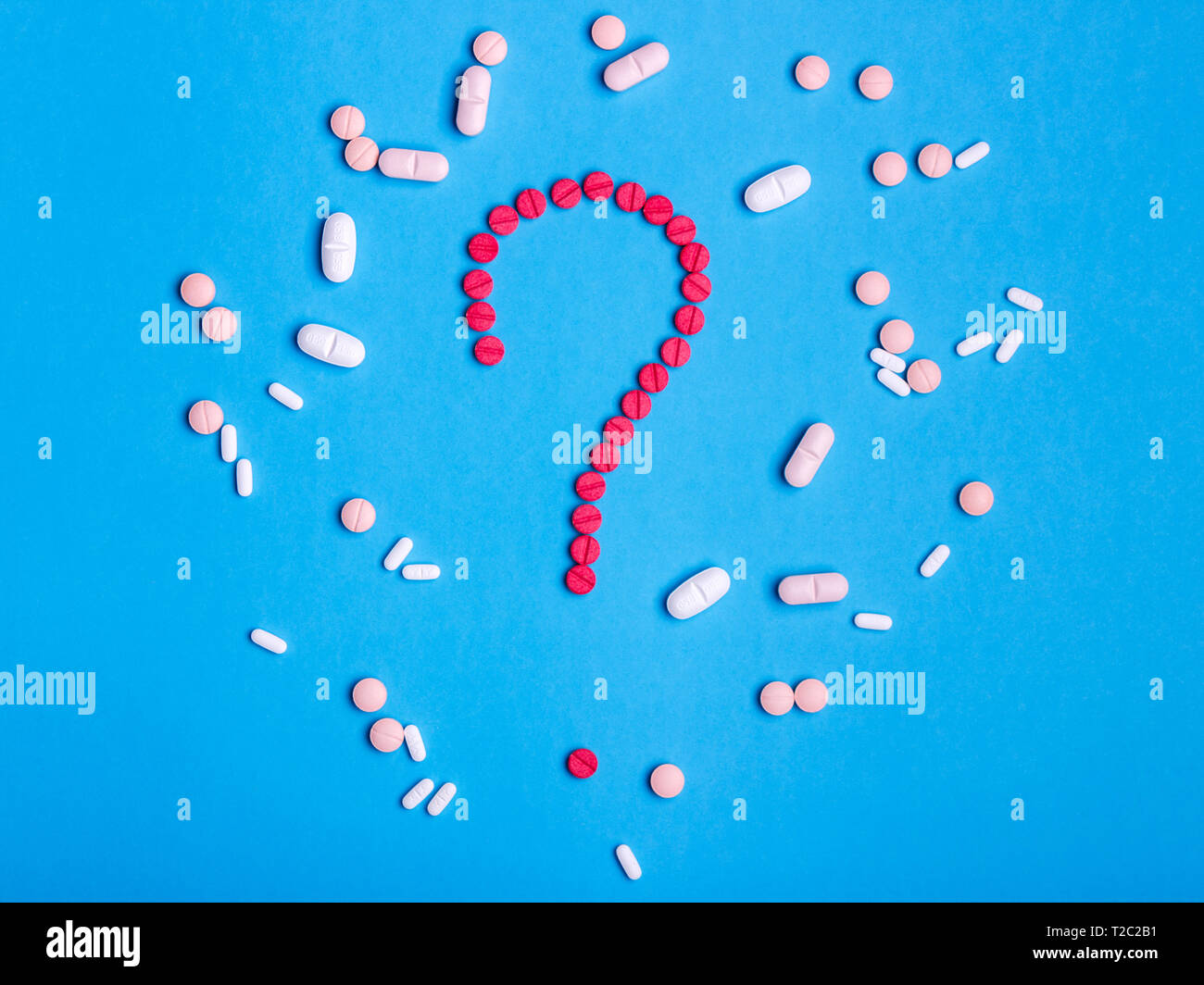 Question mark made from red medicine pills on a blue background Stock ...