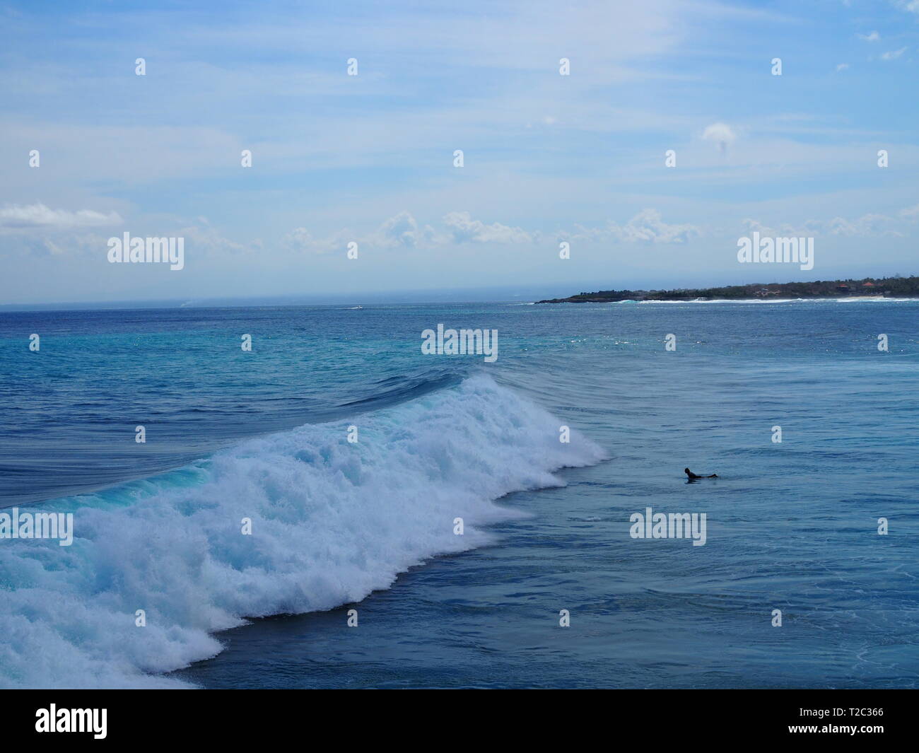 Surfing at Mahana Point, Ceningan Island, Nusa Penida, Indonesia Stock ...