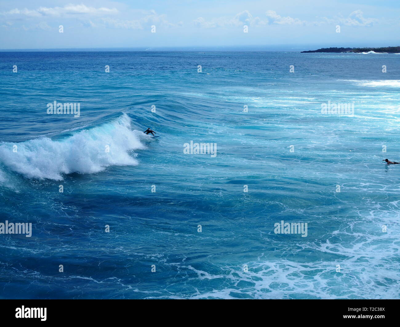 Surfing at Mahana Point, Ceningan Island, Nusa Penida, Indonesia Stock ...