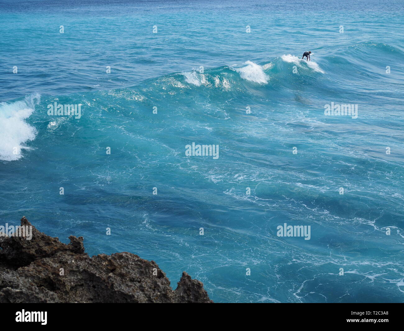 Surfing at Mahana Point, Ceningan Island, Nusa Penida, Indonesia Stock ...