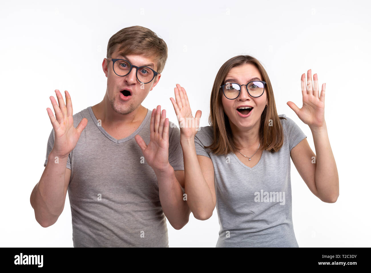 Education, people concept - a couple of young people in glasses look ...