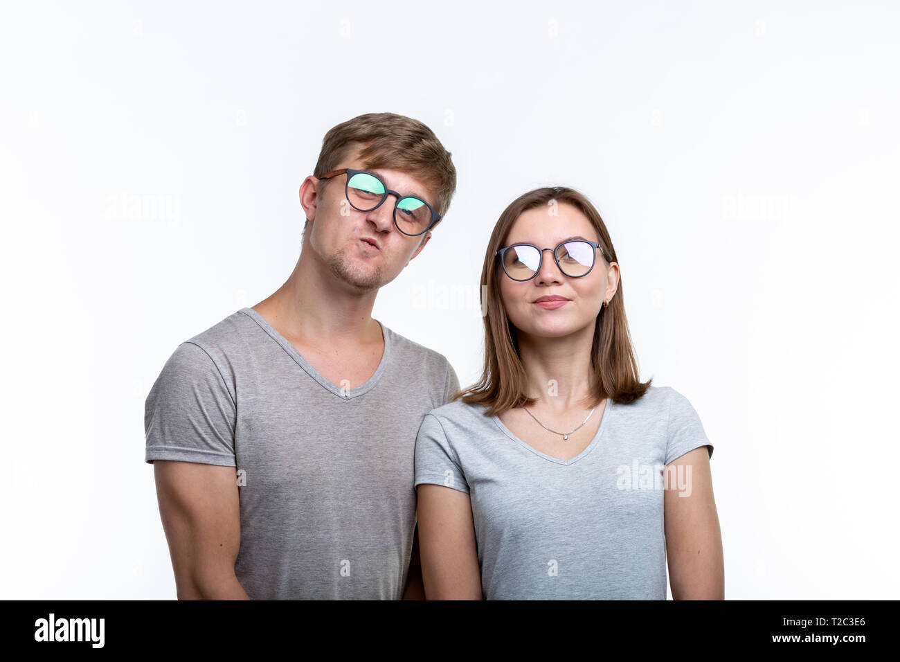 Education, people concept - a couple of young people in glasses look ...