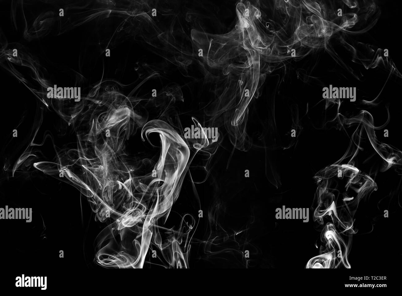 white smoke flame on a black background Stock Photo - Alamy