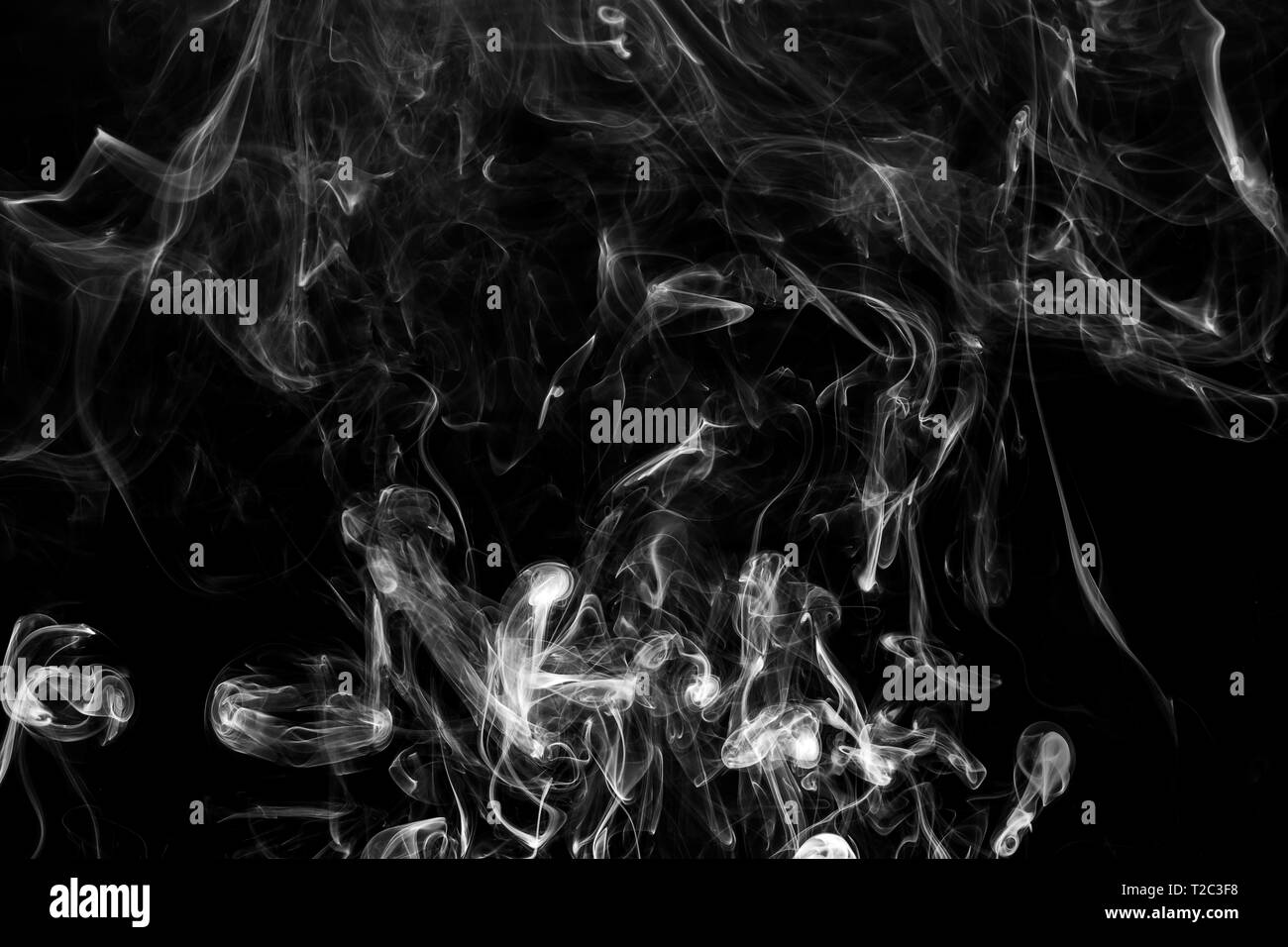 white smoke flame on a black background Stock Photo - Alamy
