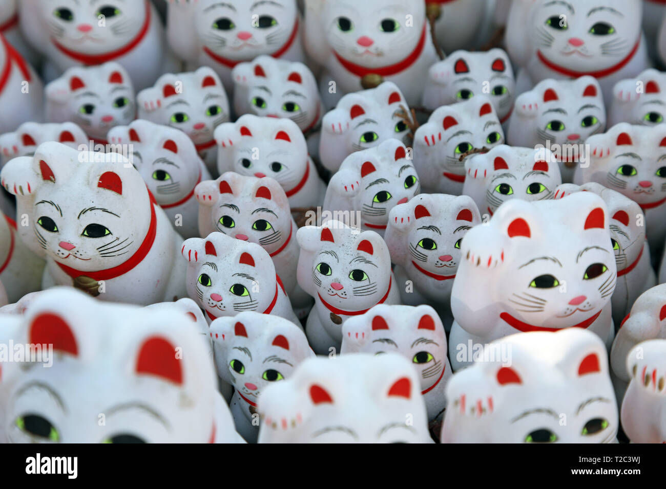Maneki-Neko waving cat statues at the Gotokuji Temple in the Setagaya district of Tokyo in Japan ...