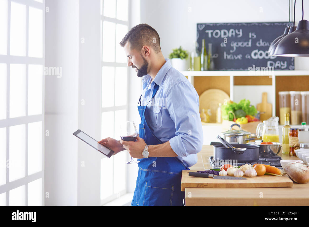 cook with a tablet in hand and studying the recipe Stock Photo - Alamy
