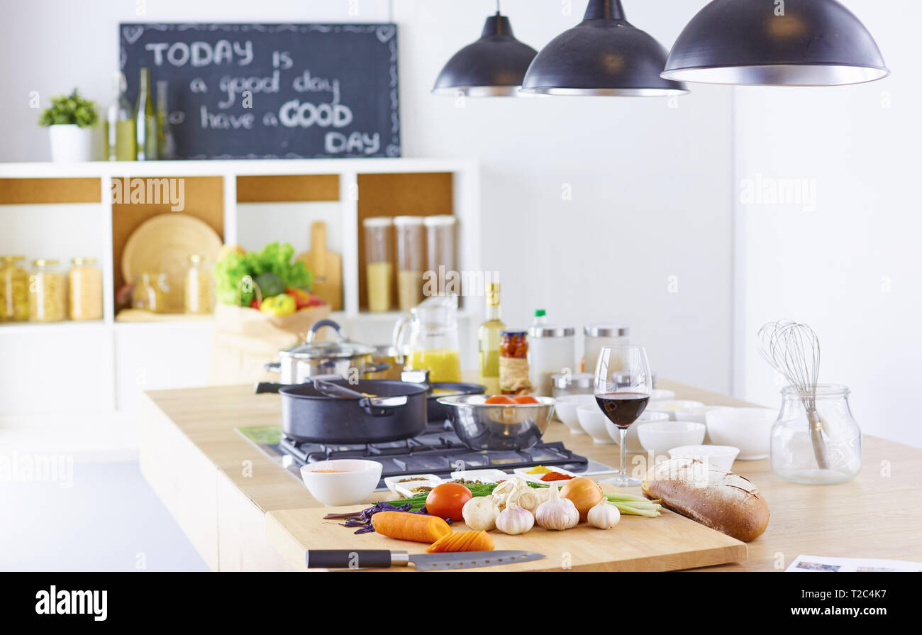 Composition with wooden board and ingredients for cooking on table ...