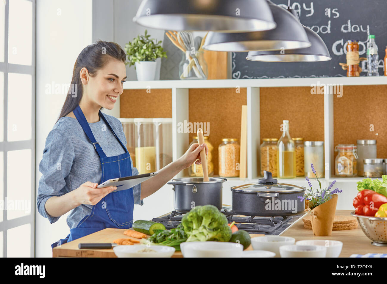 Woman cooking alone kitchen hi-res stock photography and images - Alamy