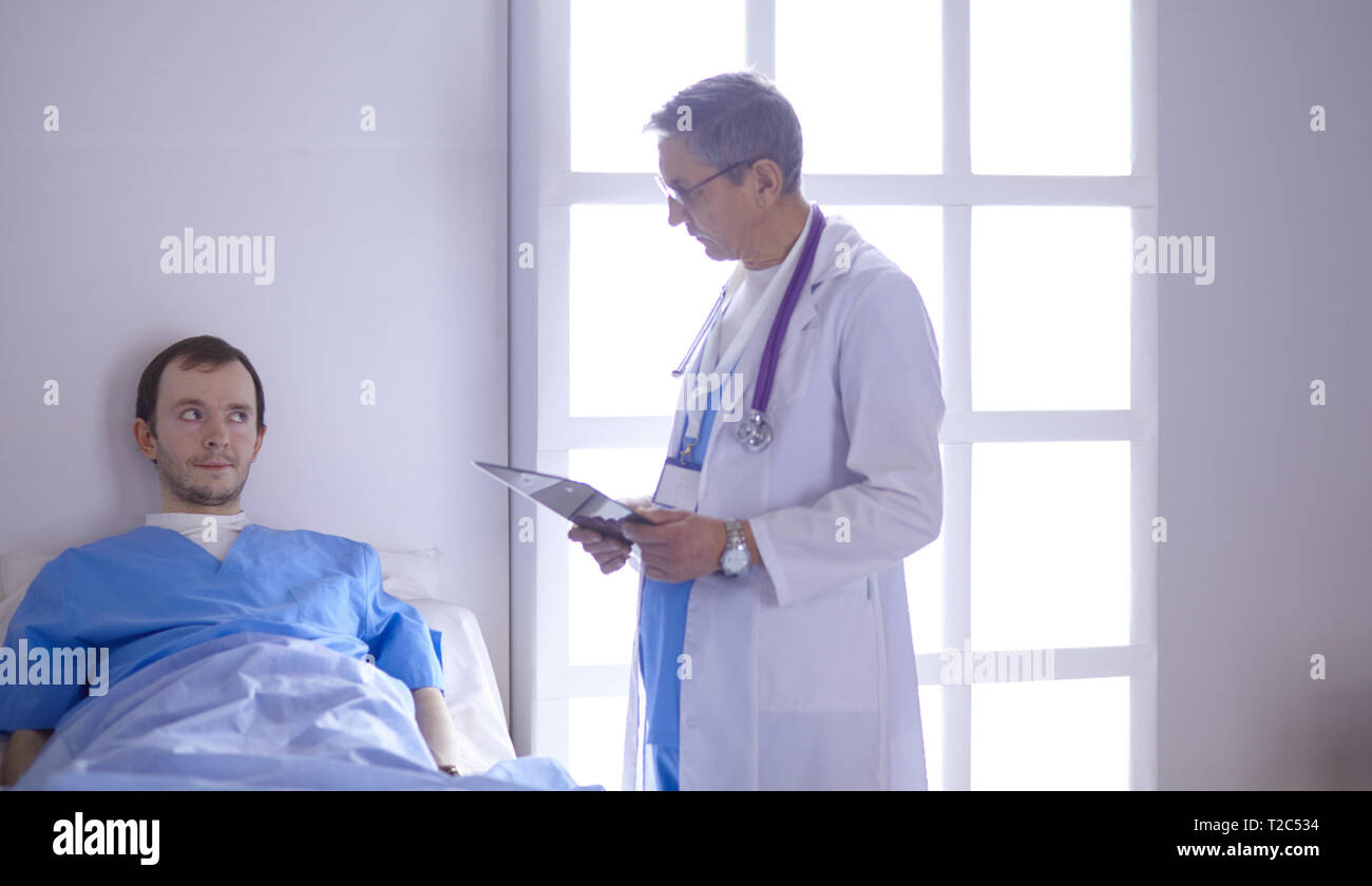 Doctor checking heart beat of patient in bed with stethoscope Stock ...