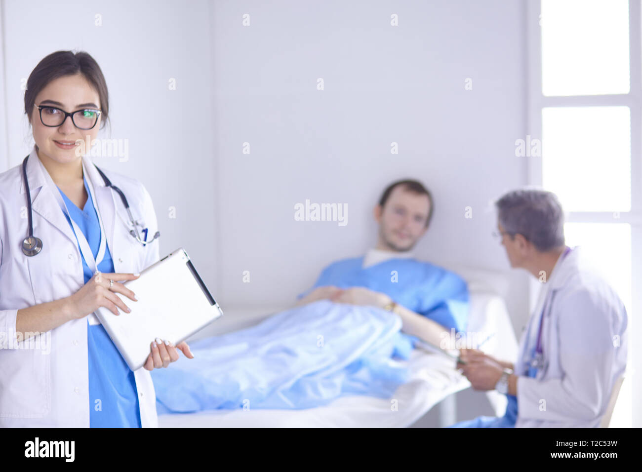 Doctor checking heart beat of patient in bed with stethoscope Stock ...