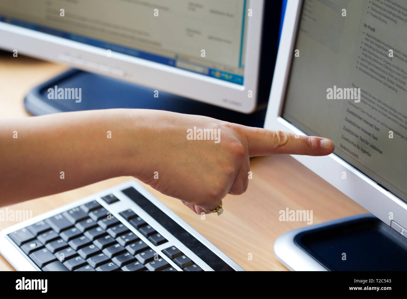 Hand pointing at computer screen Stock Photo - Alamy