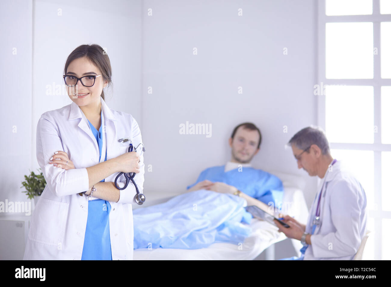 Doctor checking heart beat of patient in bed with stethoscope Stock ...
