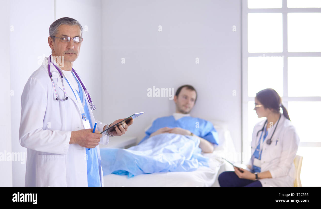 Doctor checking heart beat of patient in bed with stethoscope Stock ...