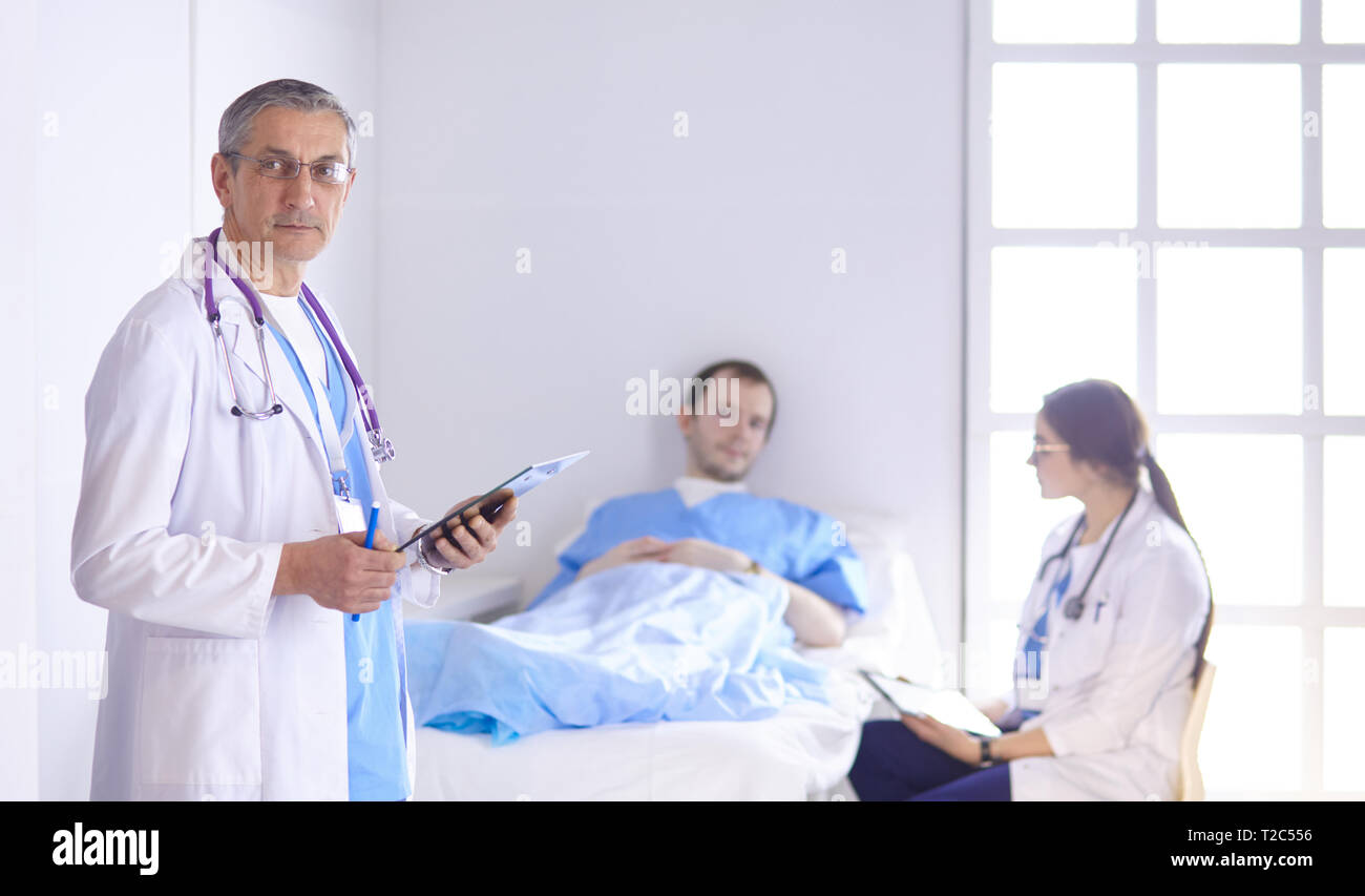 Doctor checking heart beat of patient in bed with stethoscope Stock ...