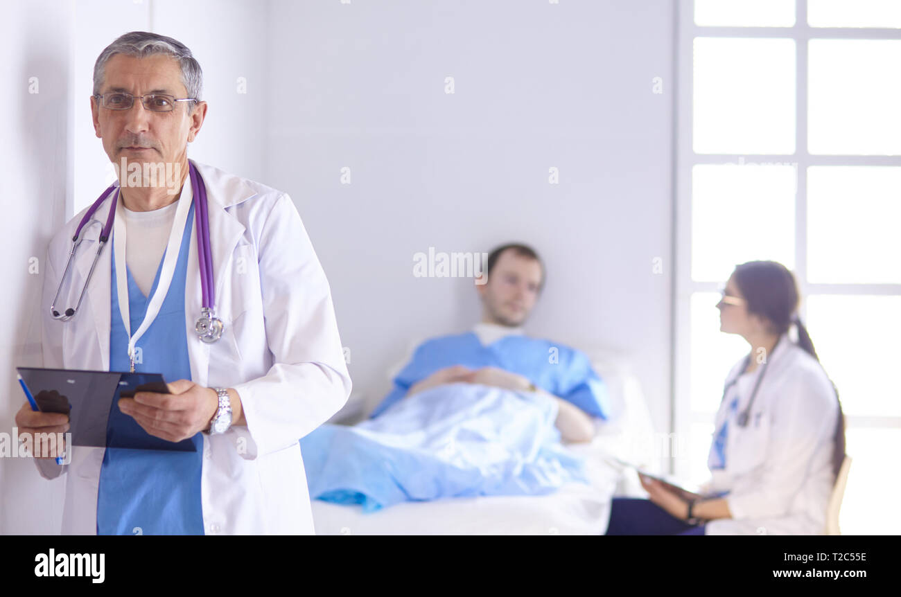 Doctor checking heart beat of patient in bed with stethoscope Stock ...