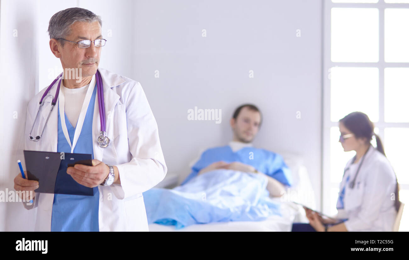 Doctor checking heart beat of patient in bed with stethoscope Stock ...