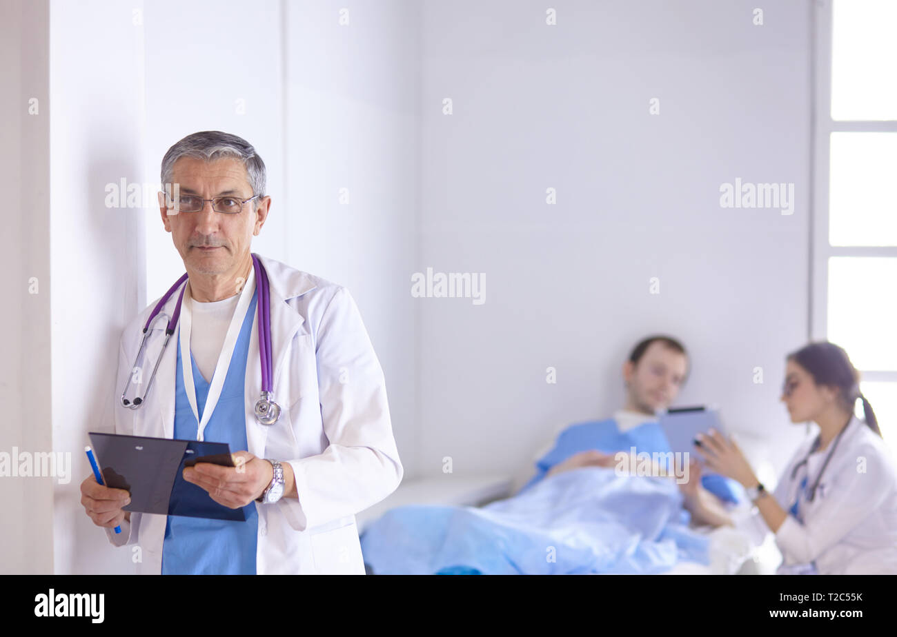 Doctor checking heart beat of patient in bed with stethoscope Stock ...