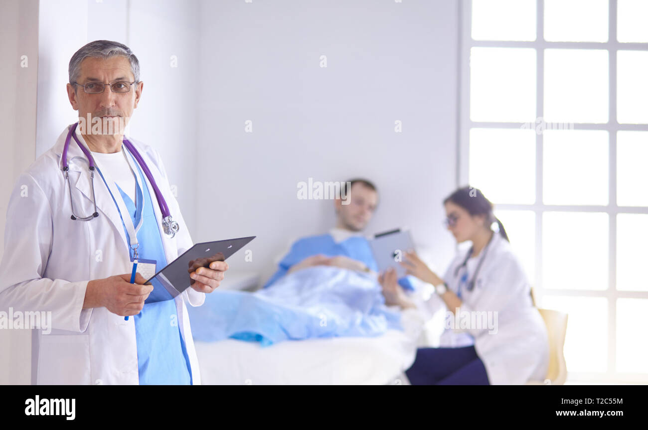 Doctor checking heart beat of patient in bed with stethoscope Stock ...