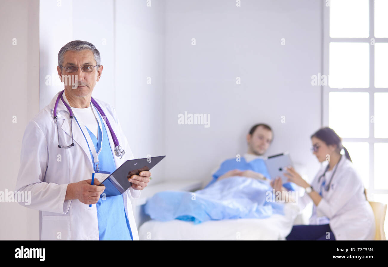 Doctor checking heart beat of patient in bed with stethoscope Stock ...