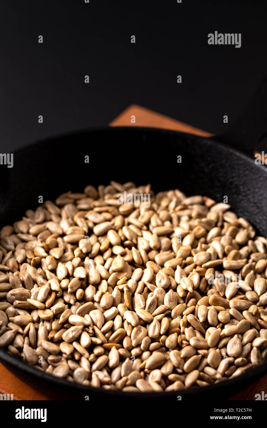 Healthy food concept roasted organic sunflower seeds in skillet iron ...