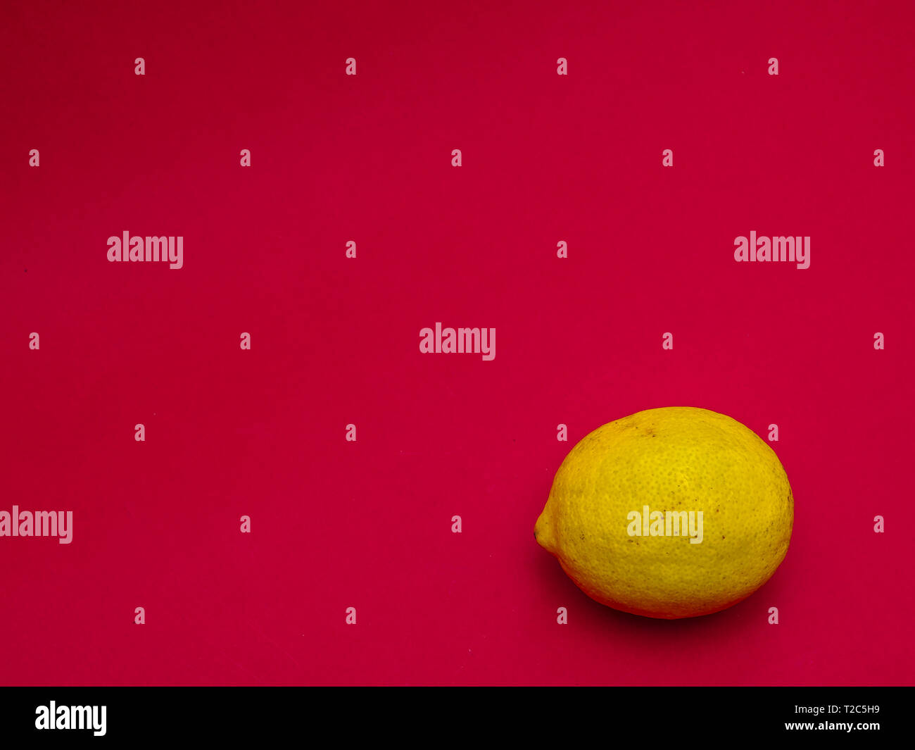 One single lemon isolated on magenta background. Upper view Stock Photo ...