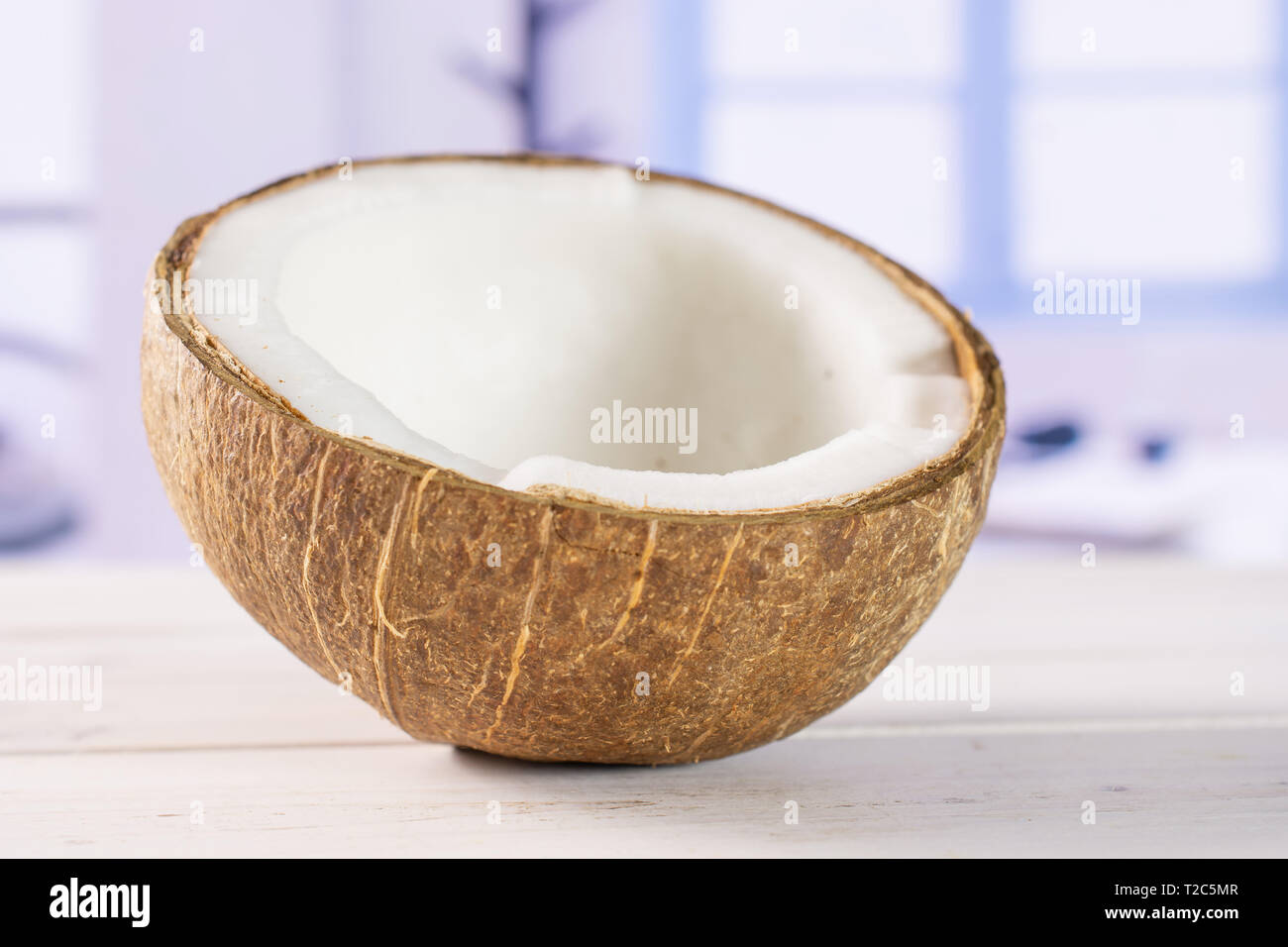 One half of fresh bio coconut with blue window in a white kitchen Stock ...
