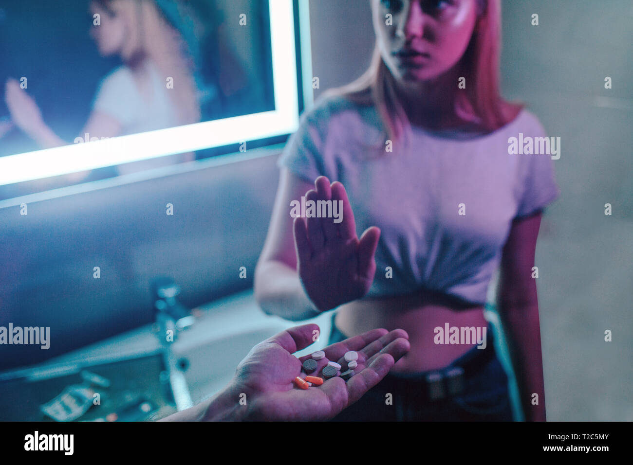 No drugs. Drug offer. Reject drugs offer. Hand saying NO. Young woman ...