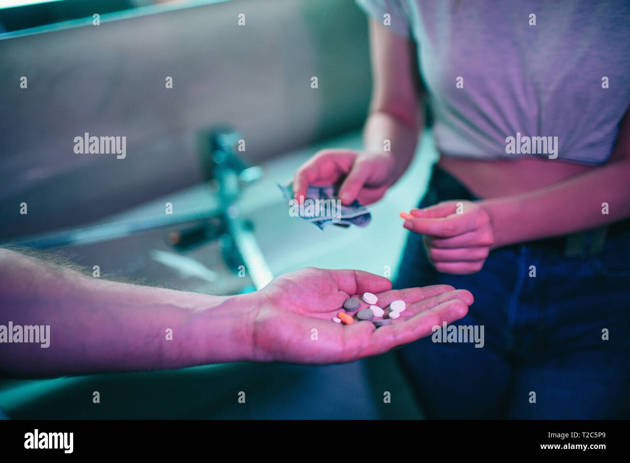 Buying drugs. Drug trafficking and sale. Hand of drug addict with money ...