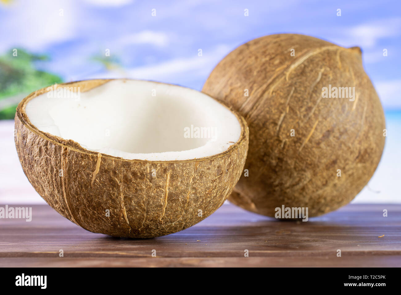 Group of one whole one half of fresh bio coconut on the beach with an ...