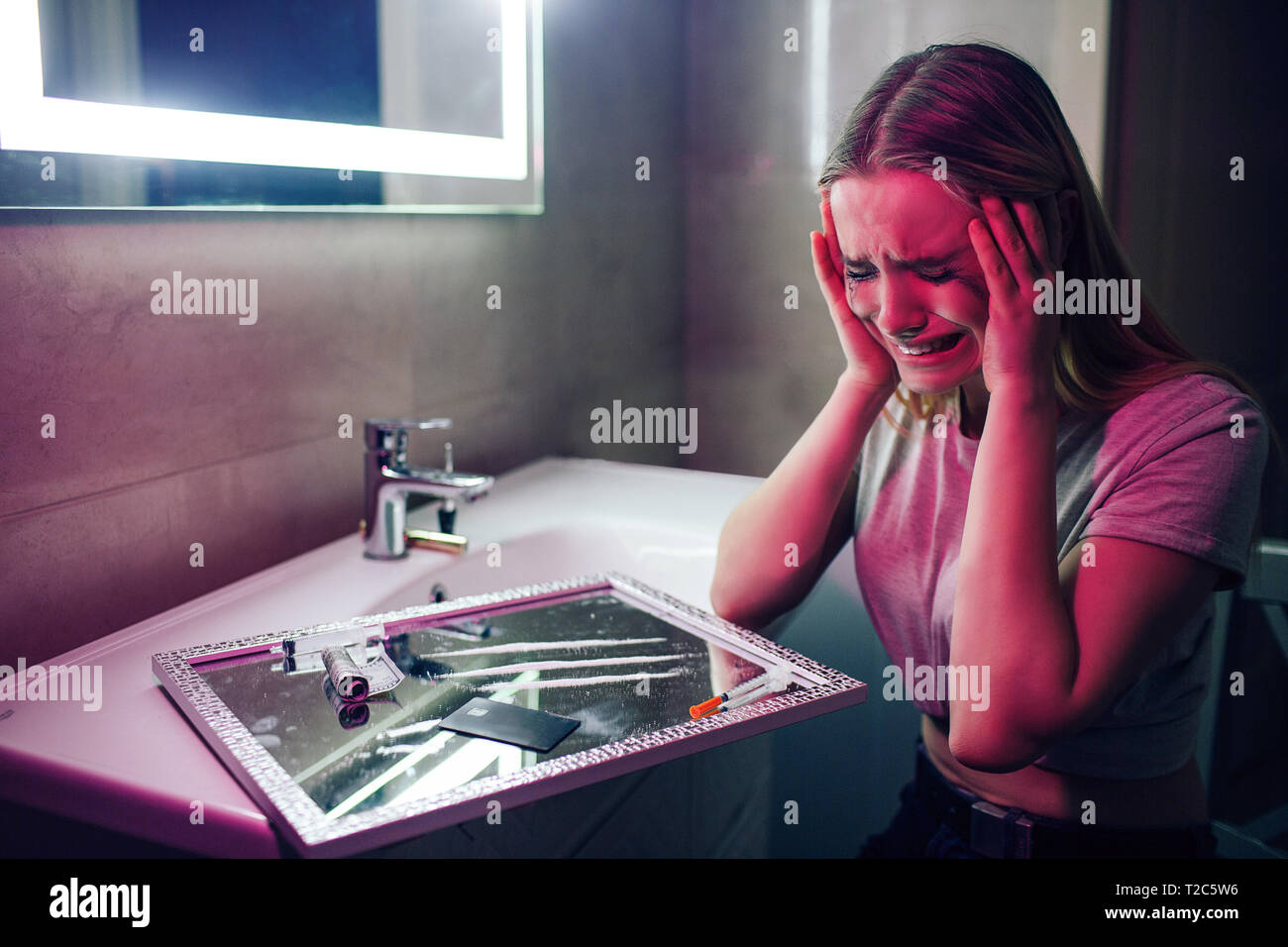 Drugs kill you. Say no to drug. Drug addict cries on drugs background ...