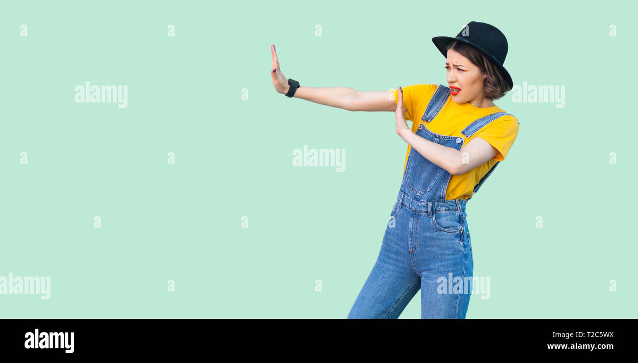 Profile side view portrait of scared young hipster girl in blue denim ...