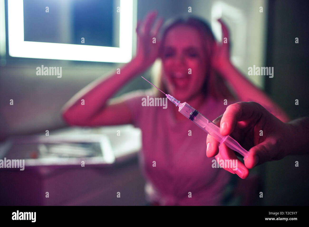 Drugs kill you. Syringe on background of screaming drug addicted woman ...