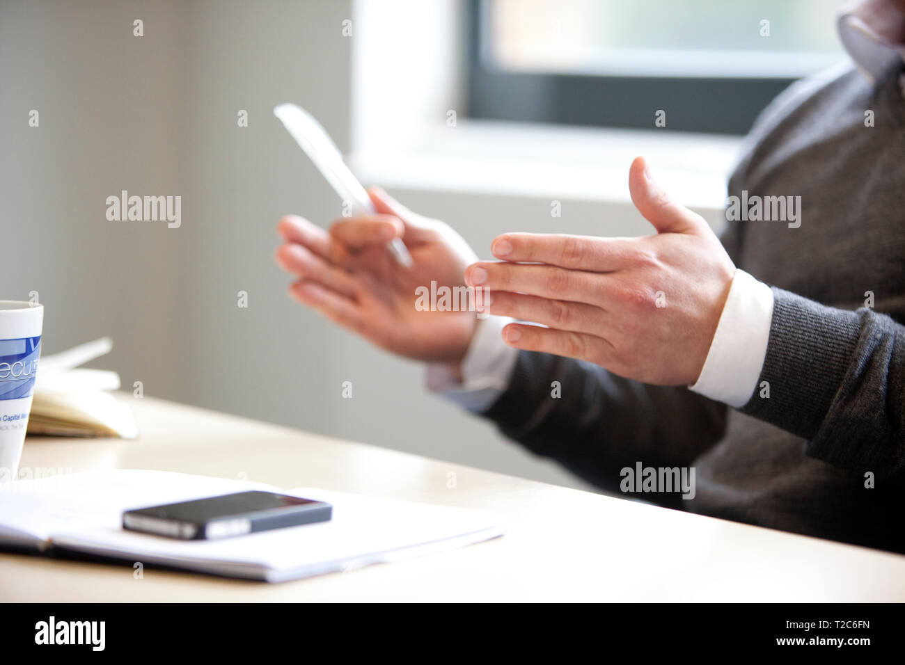 Hands of office worker engaged in discussion Stock Photo - Alamy