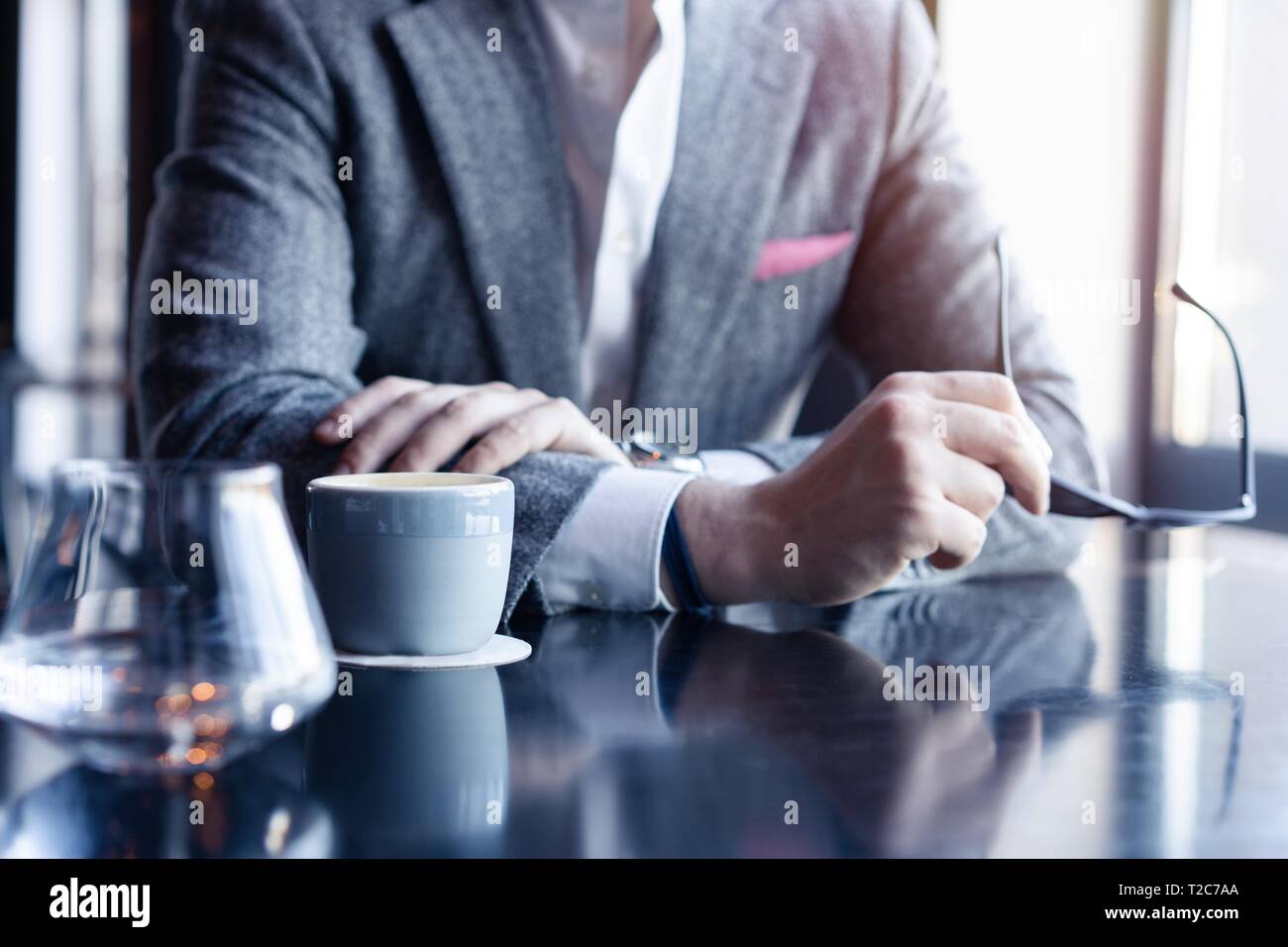 Take a break and have coffee. Business man drinking coffee in a cafe ...