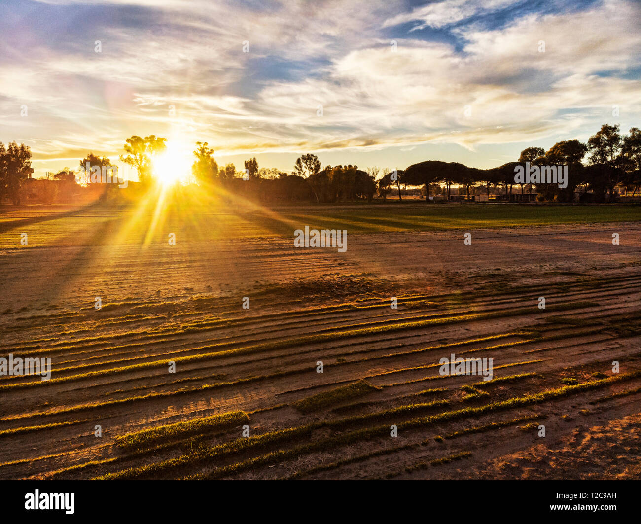Amazing sunset in the countryside above the cultivated fields and the ...
